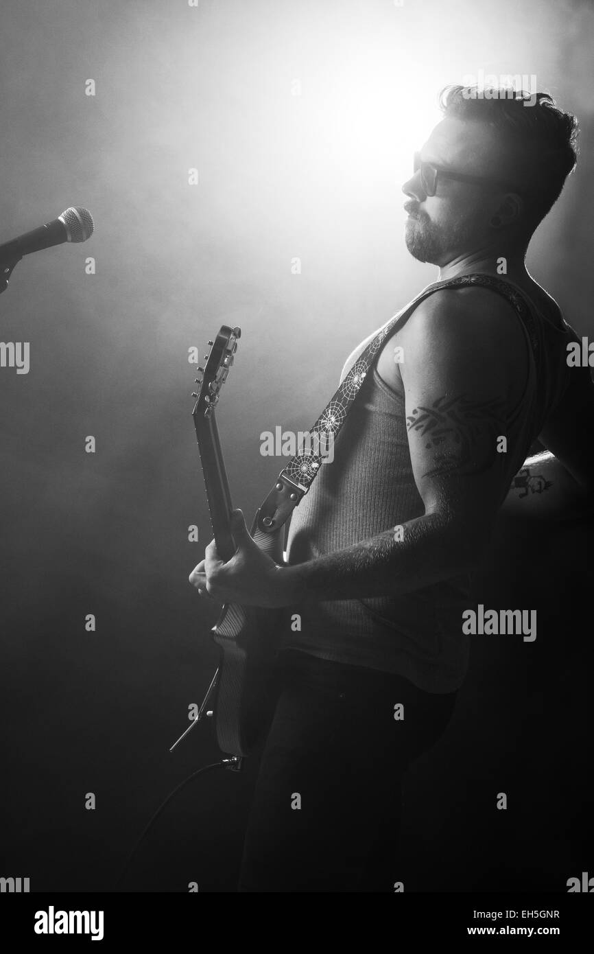 Man playing rock concert with attitude. Sings and play guitar Stock ...