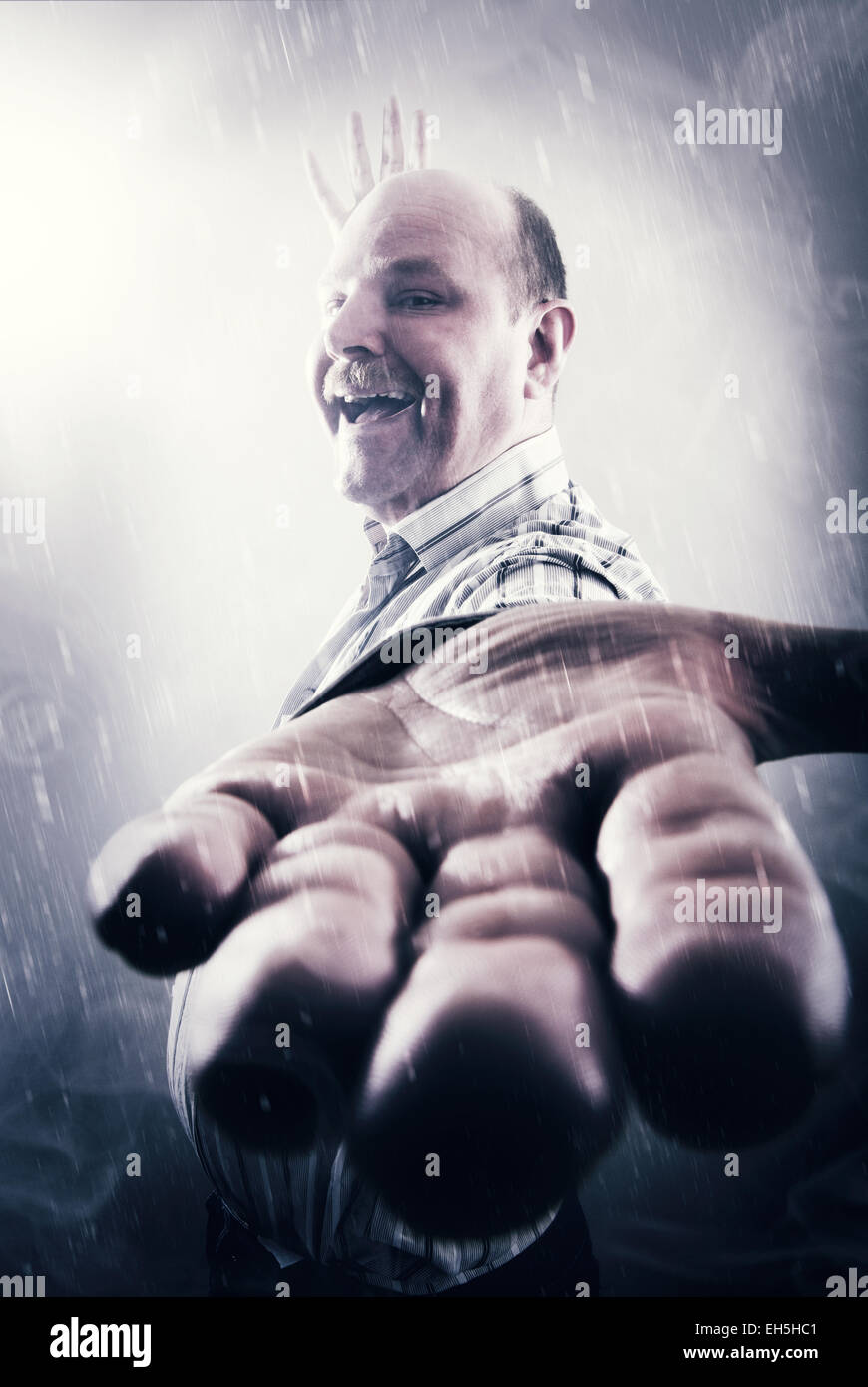 Wierd and strange guy with mustache in smoke and snow. Holding his hand ...