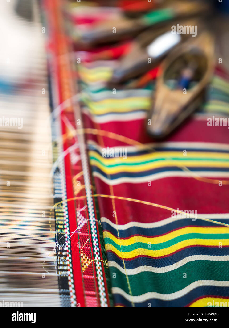 Weaving shuttles and textured textile with pattern. Artistic shallow ...
