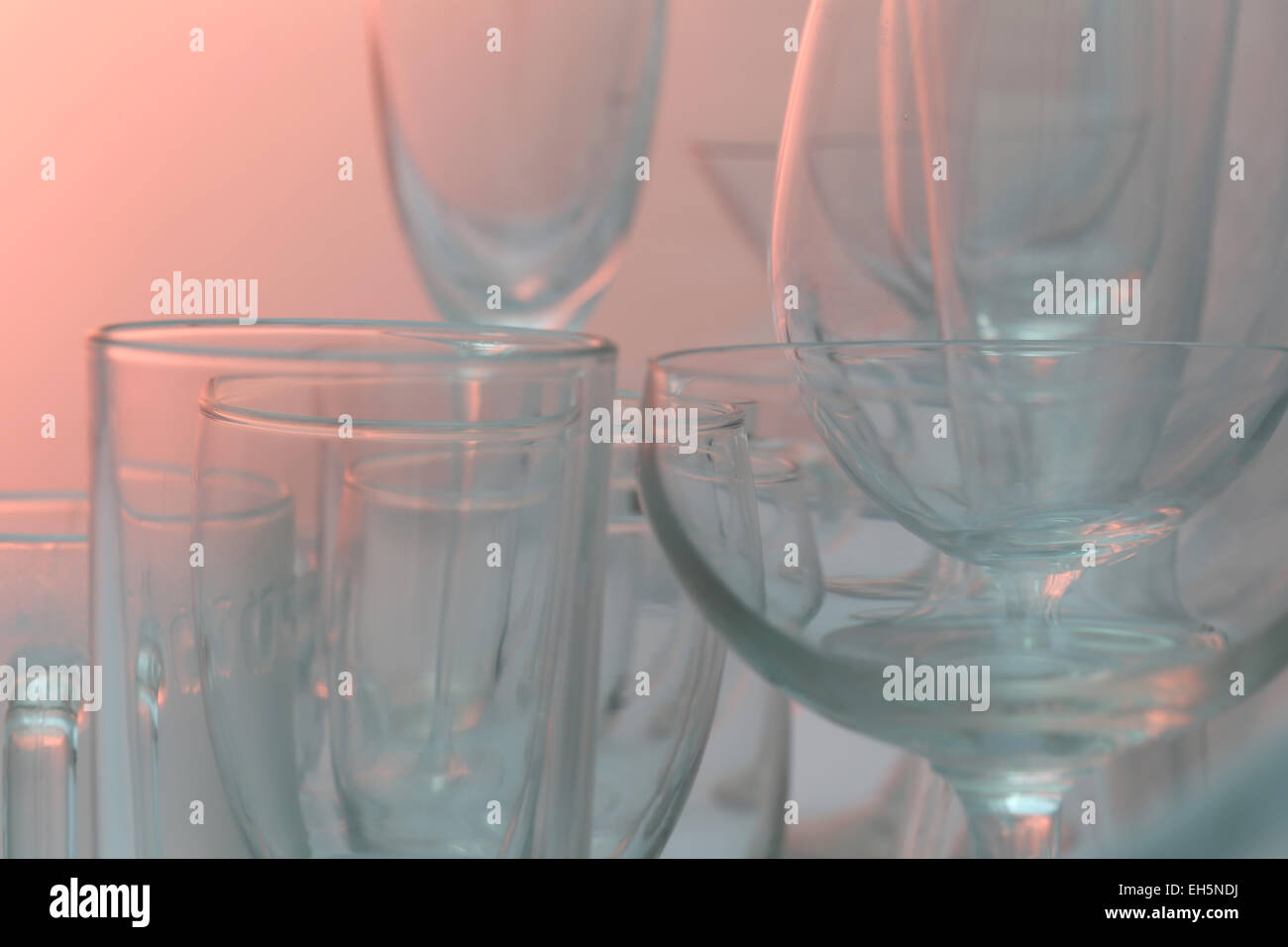 Focus in many glass on the orange background Stock Photo - Alamy