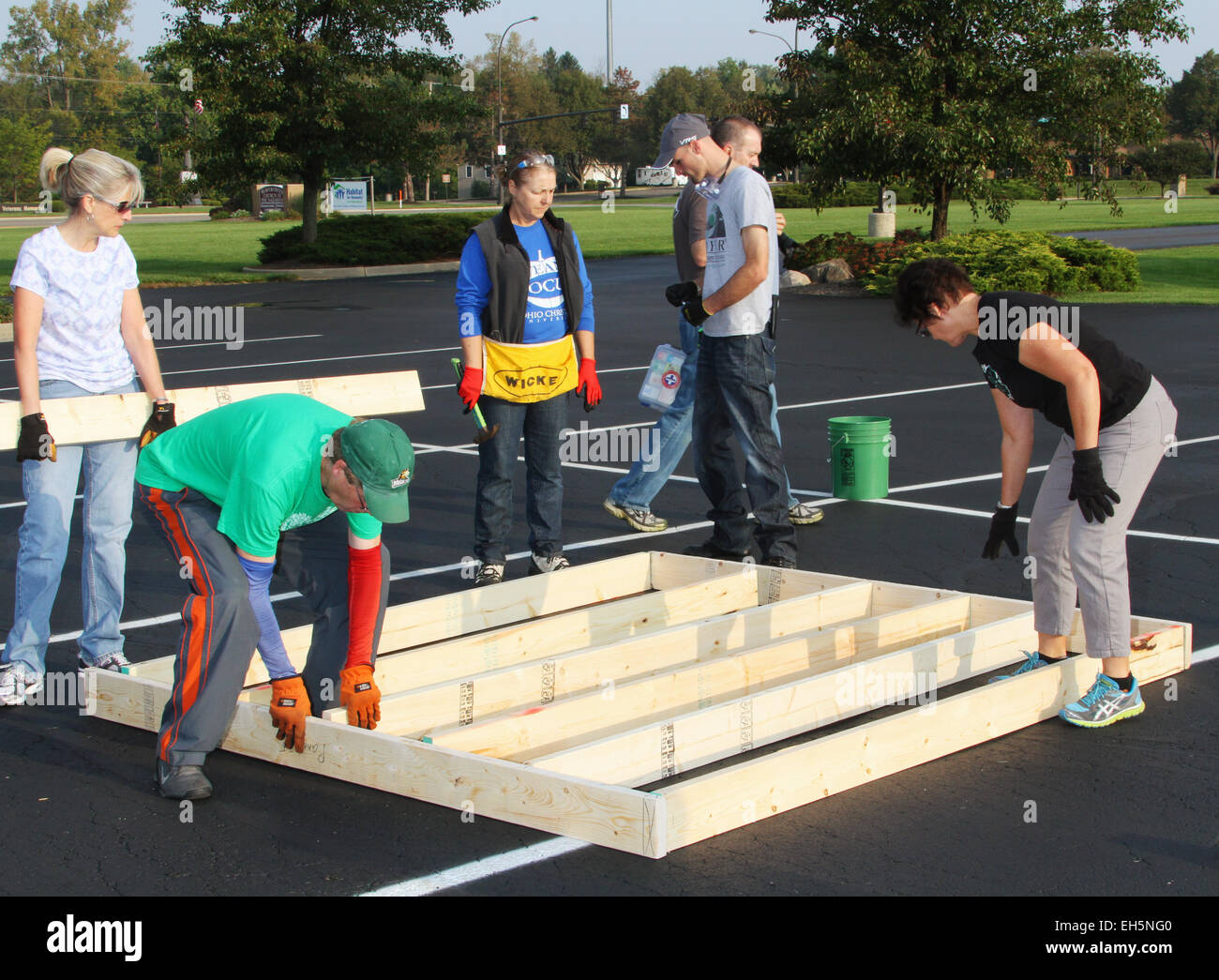 Volunteer people building a house wall panel. Habitat For Humanity ...
