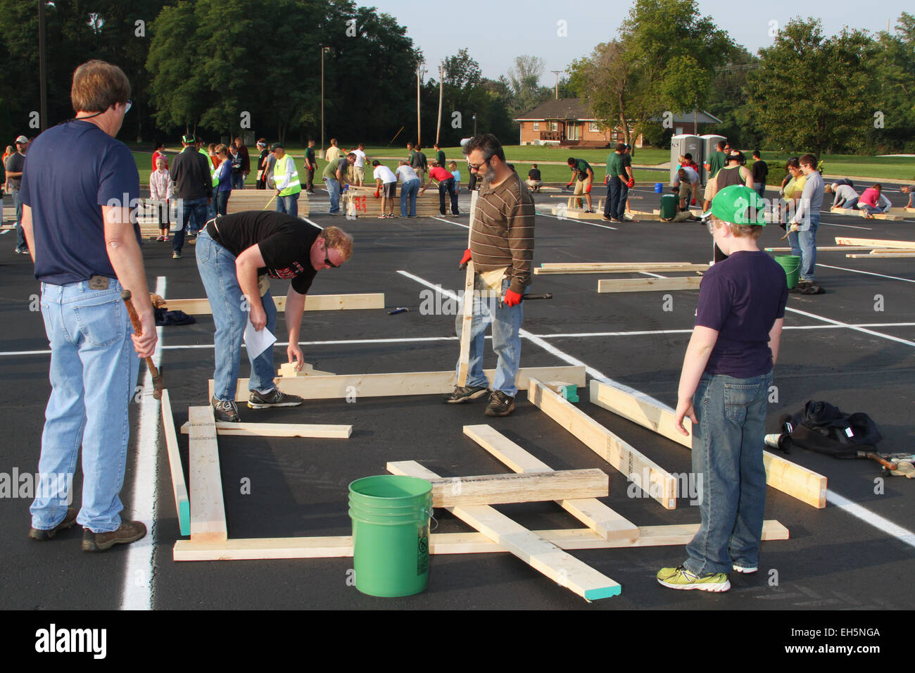 Volunteer people building a house wall panel. Habitat For Humanity ...