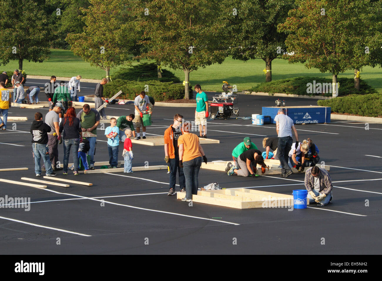 Volunteer people building a house wall panel. Habitat For Humanity ...