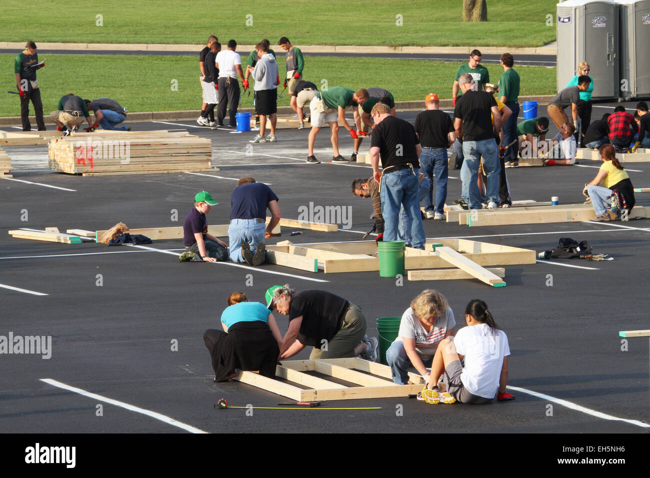 Volunteer people building a house wall panel. Habitat For Humanity ...