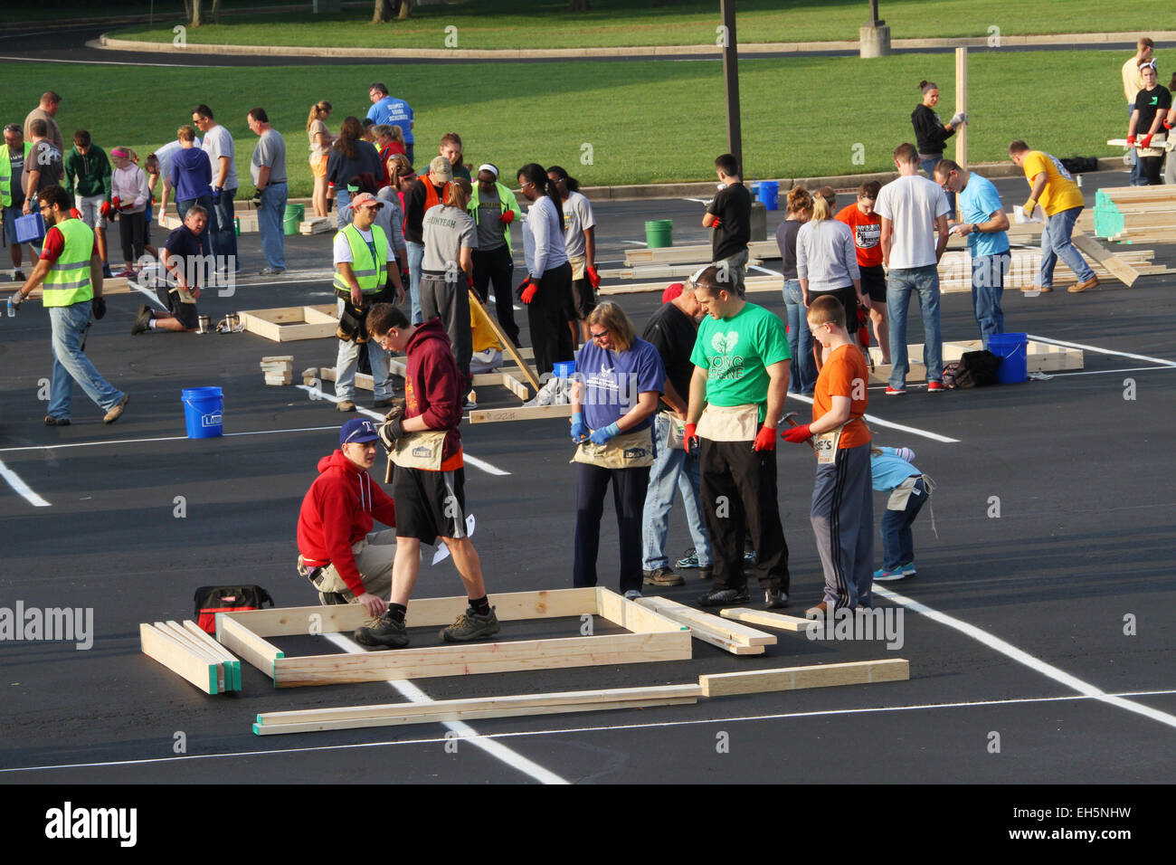 Volunteer people building a house wall panel. Habitat For Humanity ...