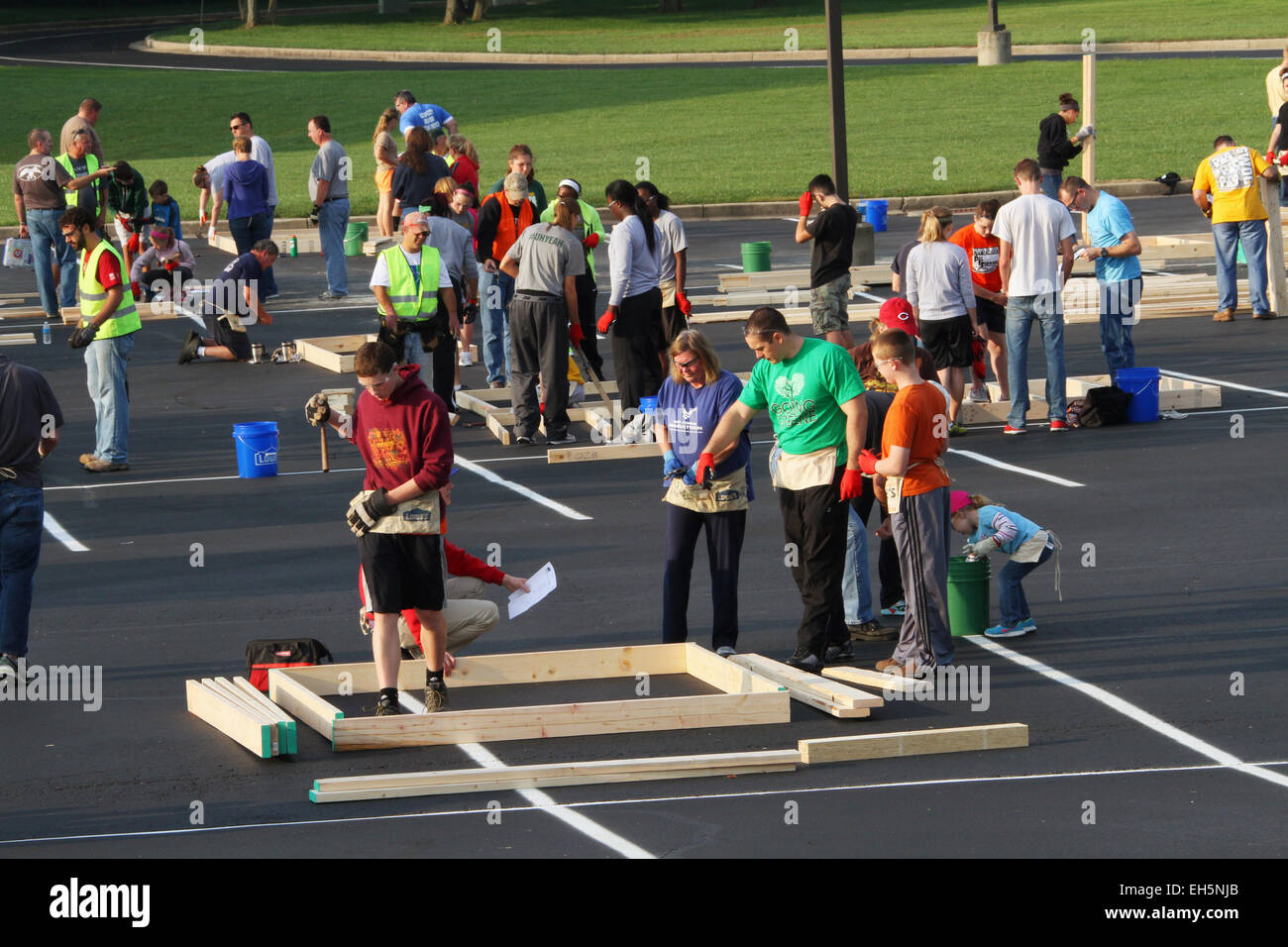 Volunteer people building a house wall panel. Habitat For Humanity ...