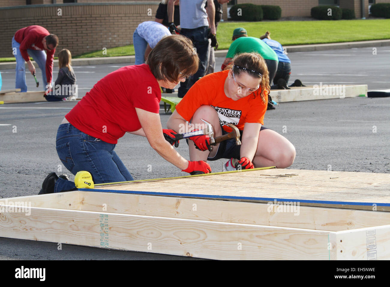 Two women. Volunteer people building a house wall panel. Habitat For ...