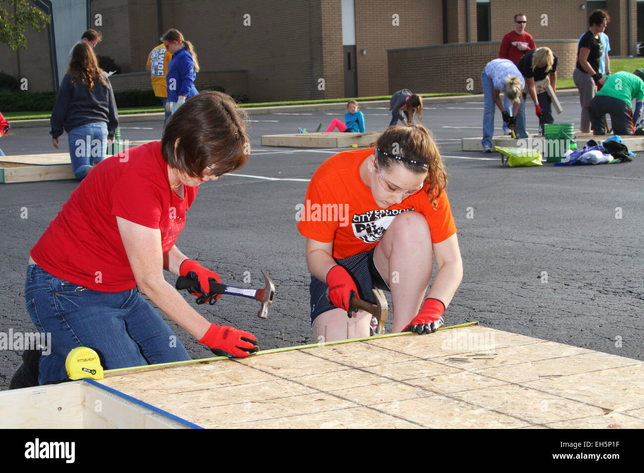 Two women. Volunteer people building a house wall panel. Habitat For ...