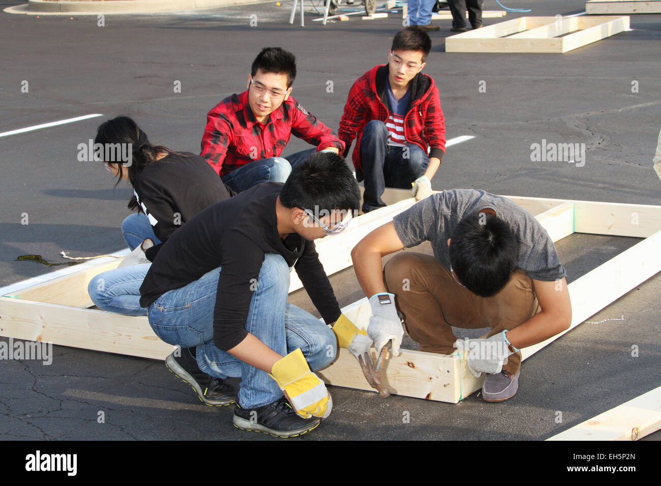 Volunteer people building a house wall panel. Habitat For Humanity ...