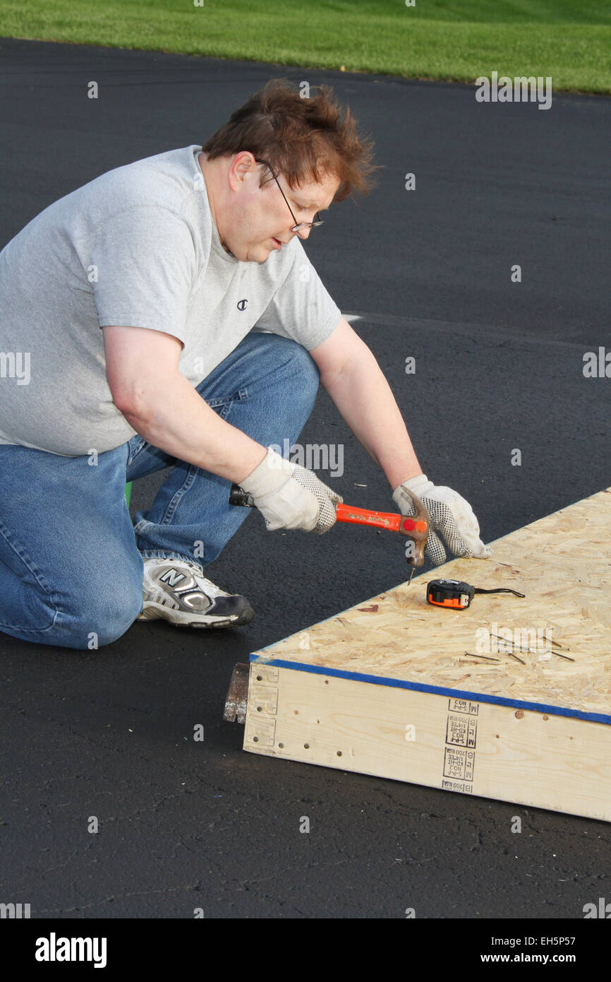 Volunteer people building a house wall panel. Habitat For Humanity ...