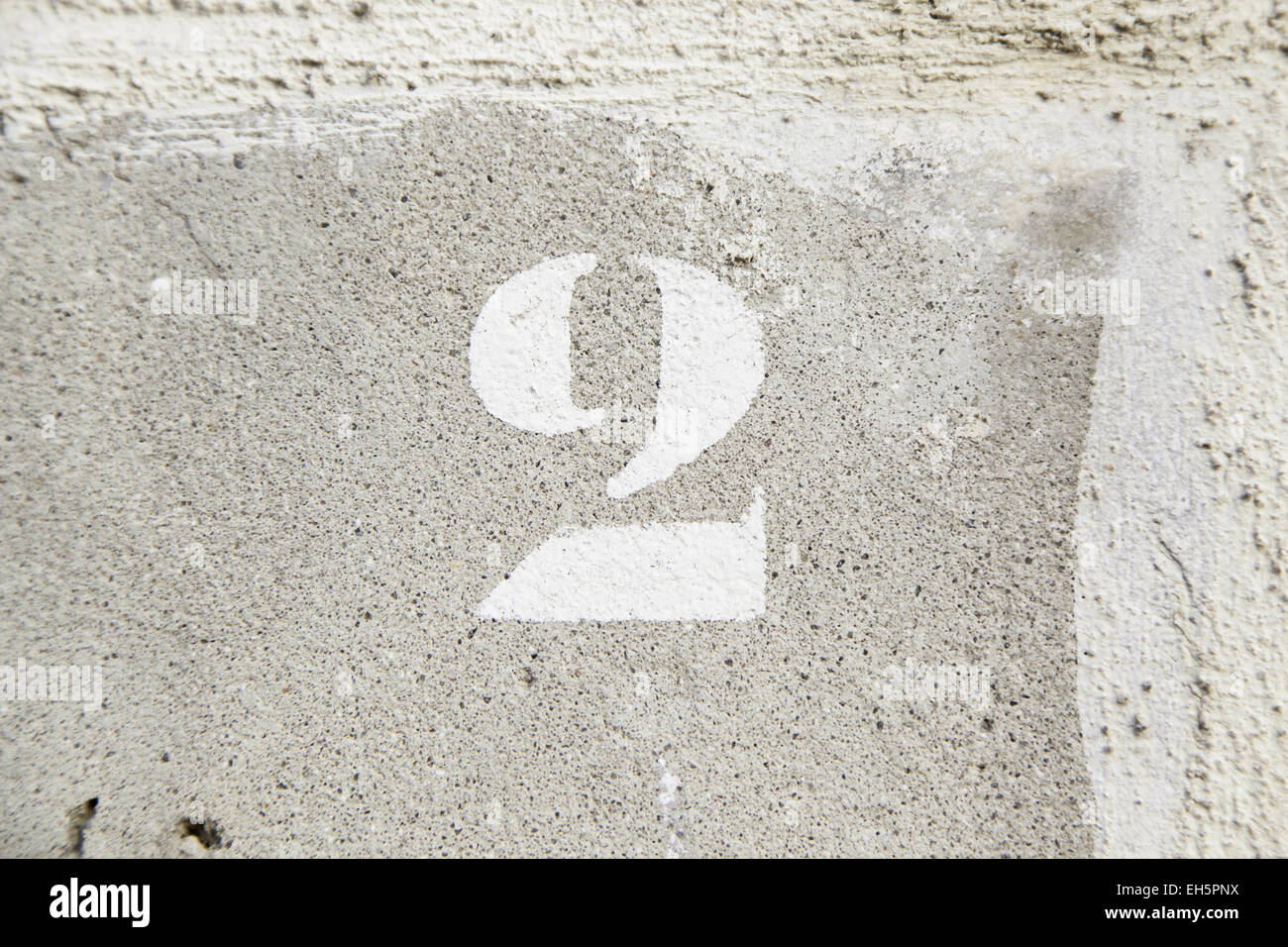Number two by a brick wall, detail of a number of information, even ...