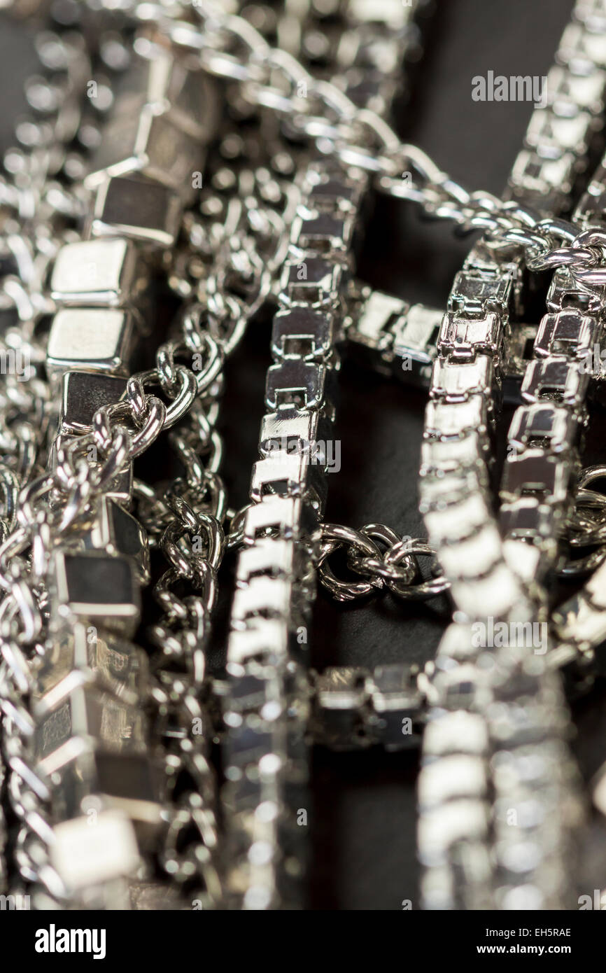 Pile of assorted silver chains with shiny box chains, cube chains and ...