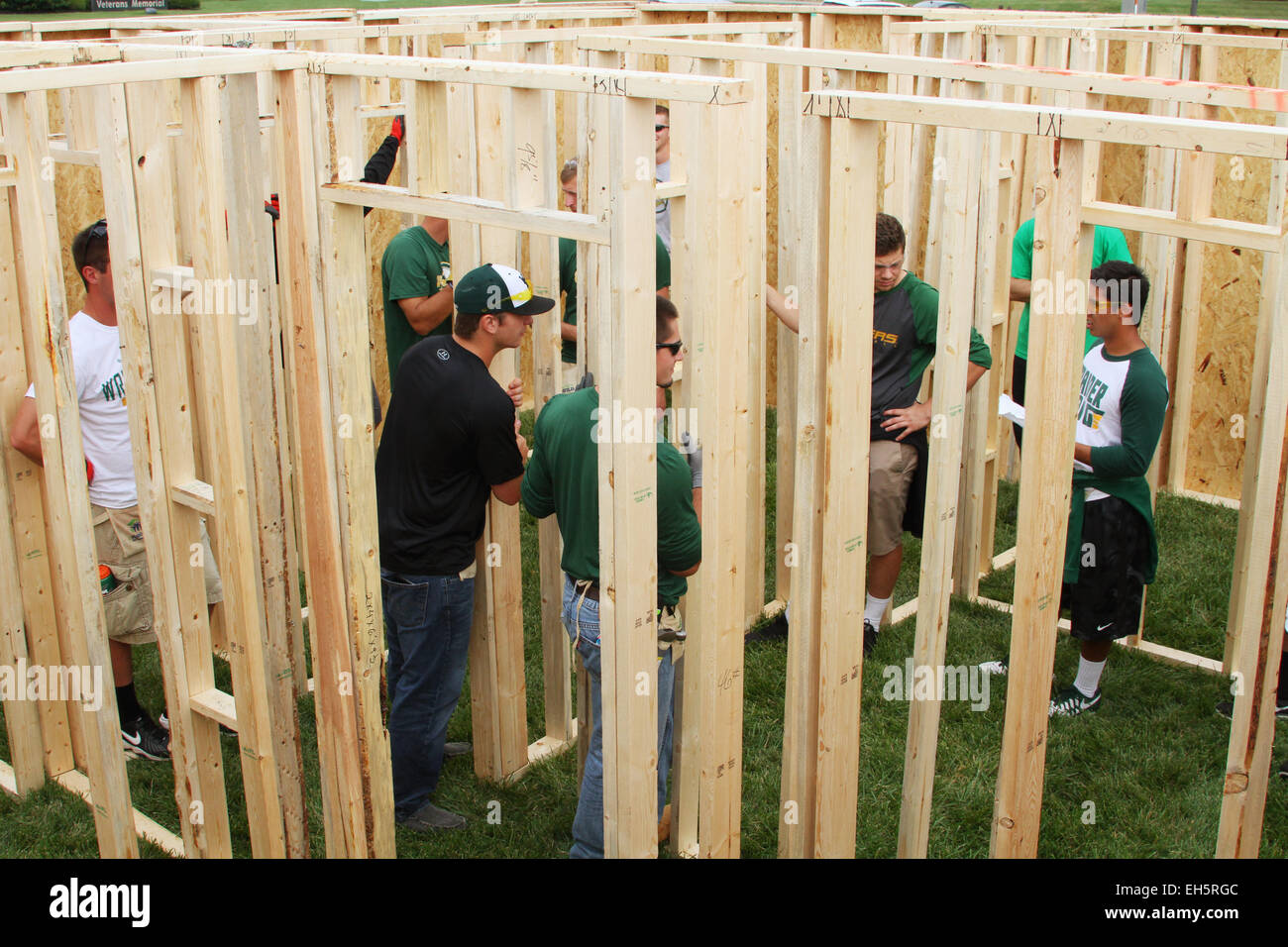 Volunteer people building a house wall panel. Habitat For Humanity ...