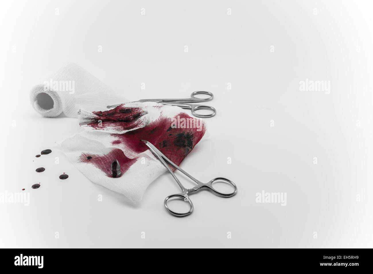 Surgical composition with bullet, blood and bandage Stock Photo - Alamy