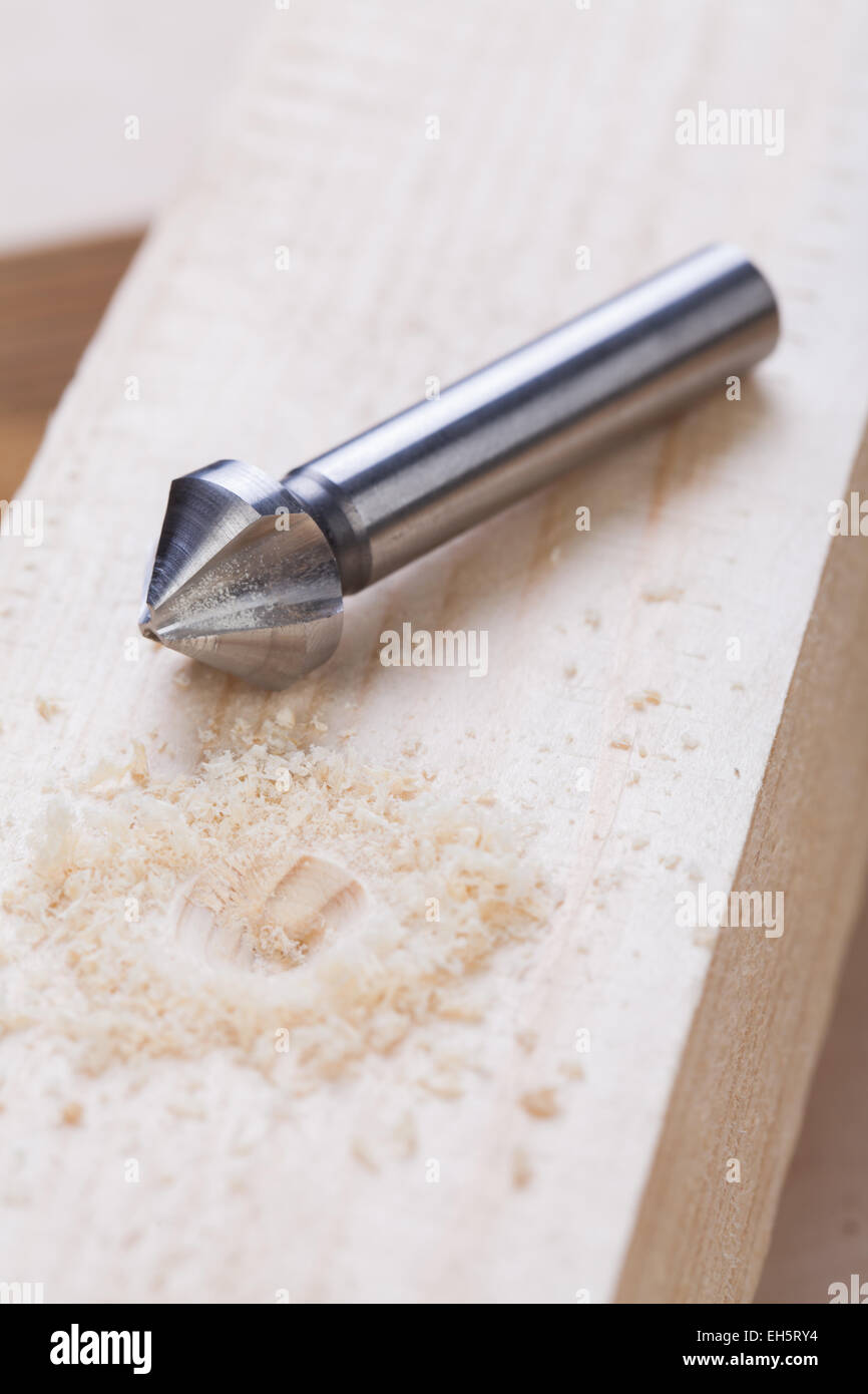 Battery operated hand drill standing amongst planks of new wood with a ...