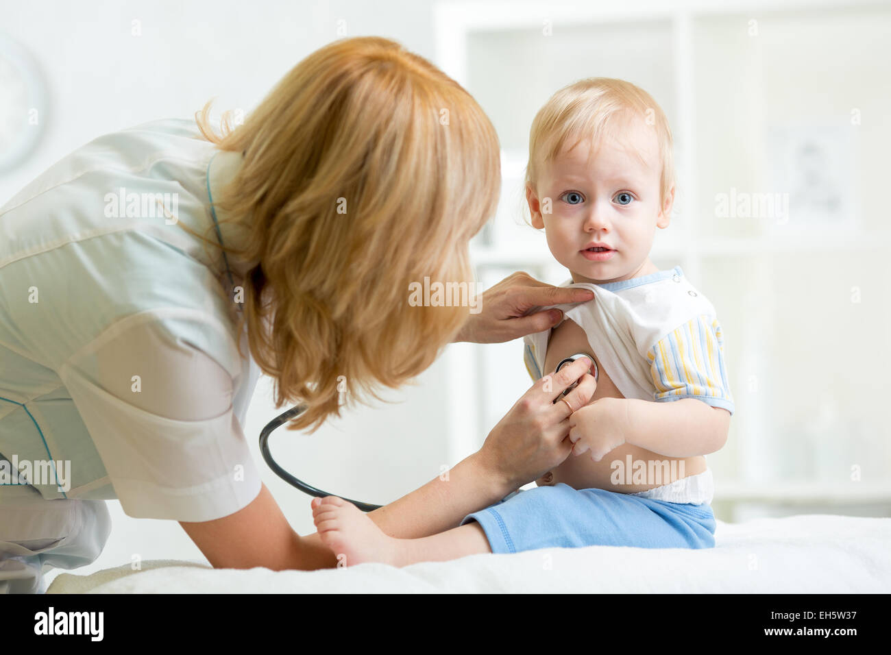 pediatrician examining heartbeat of kid with stethoscope Stock Photo ...