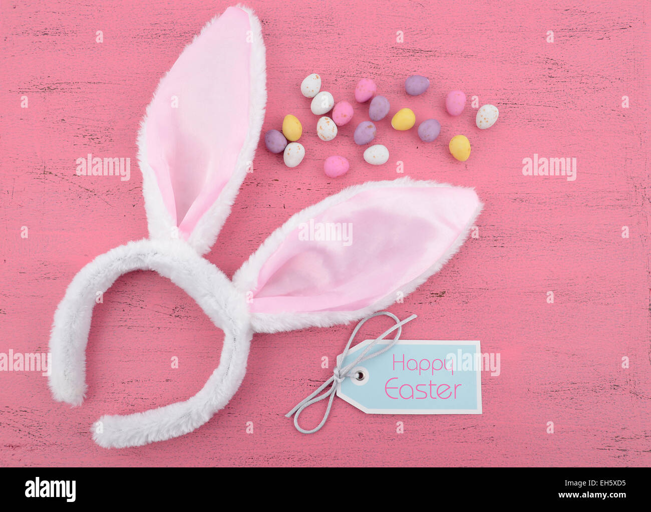 Happy Easter bunny ears with Easter eggs on pink wood background Stock ...