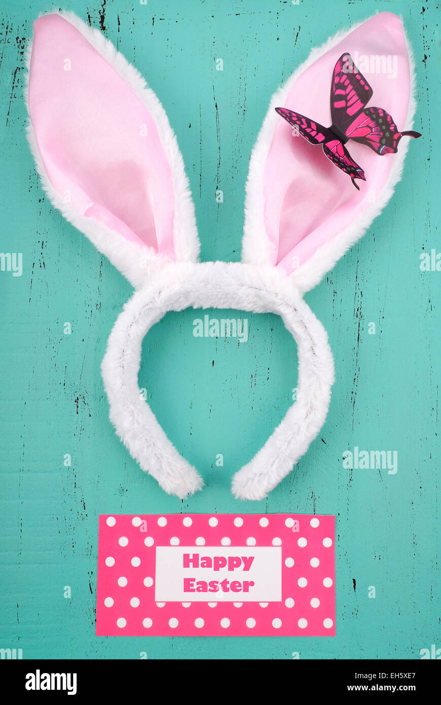 Happy Easter pink bunny ears on aqua blue wood table Stock Photo - Alamy