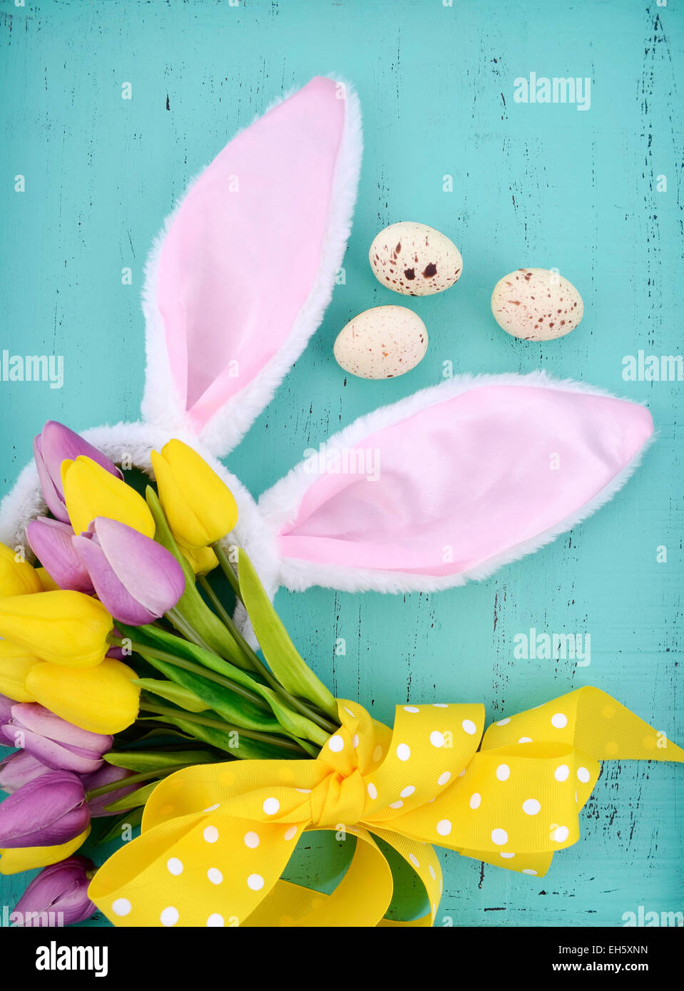 Happy Easter pink bunny ears on aqua blue wood table Stock Photo - Alamy