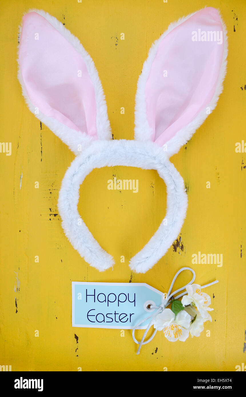 Happy Easter pink and white bunny ears on yellow wood background Stock ...