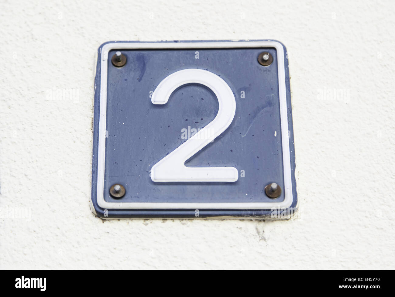 Number two by a brick wall, detail of a number of information, even ...