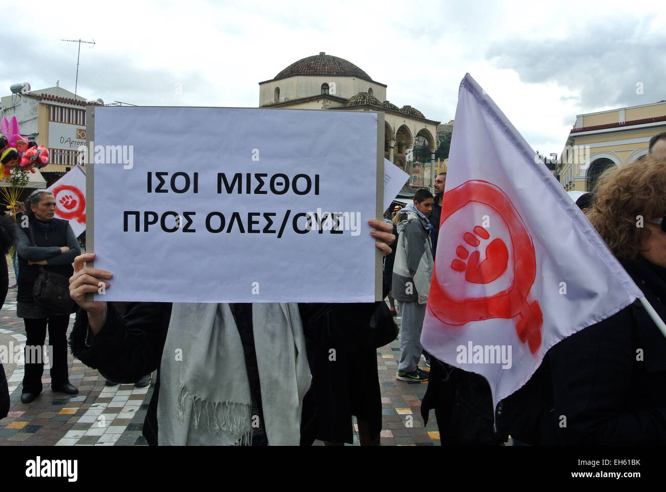 A demonstrator carries a picket with the phrase "Equal benefits and ...