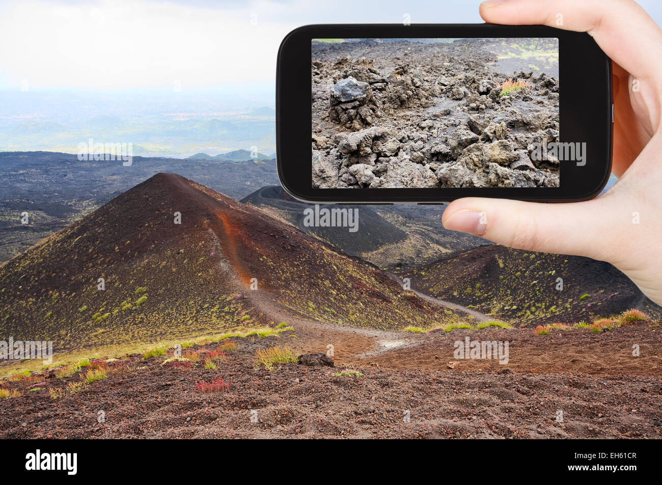 travel concept - tourist taking photo of craters volcano Etna on mobile ...