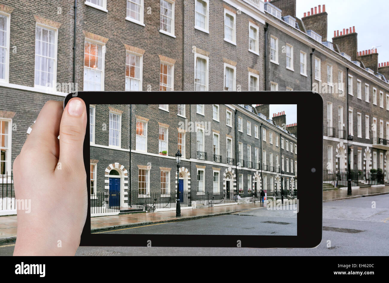 travel concept - tourist taking photo of houses in London in overcast ...