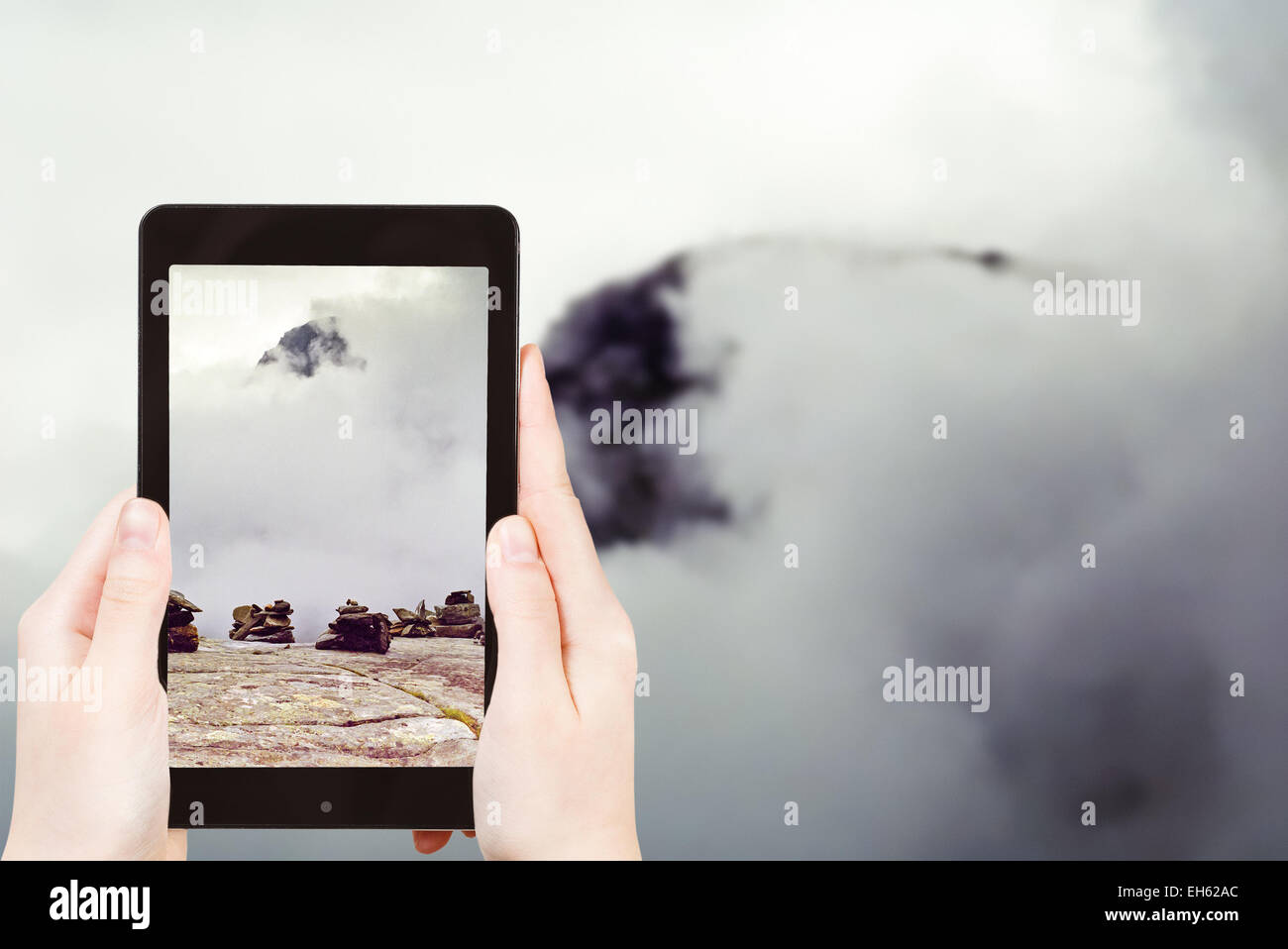 travel concept - tourist taking photo of stone pyramid on mountain ...
