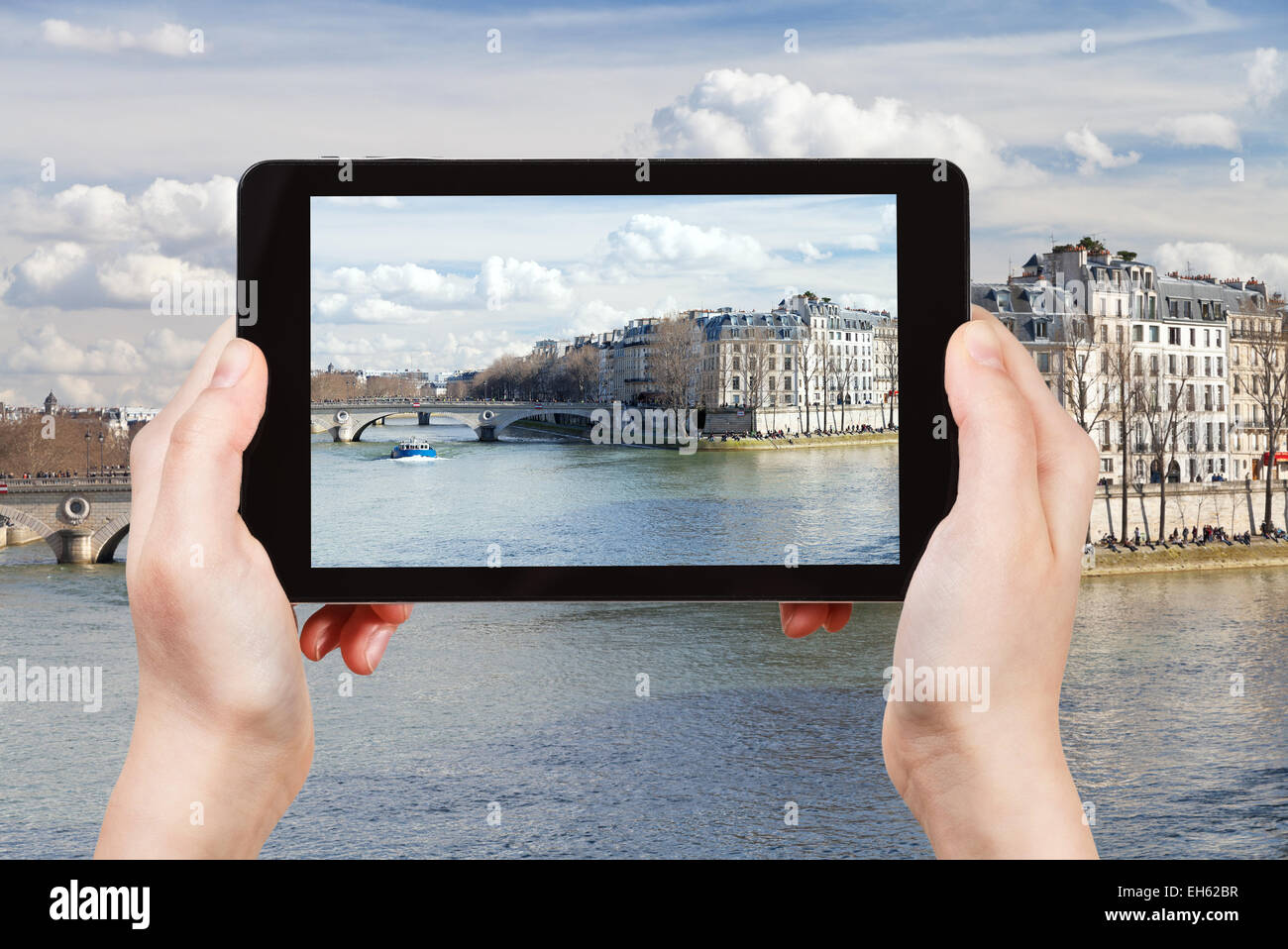 travel concept - tourist taking photo of Seine river and Pont Louis ...