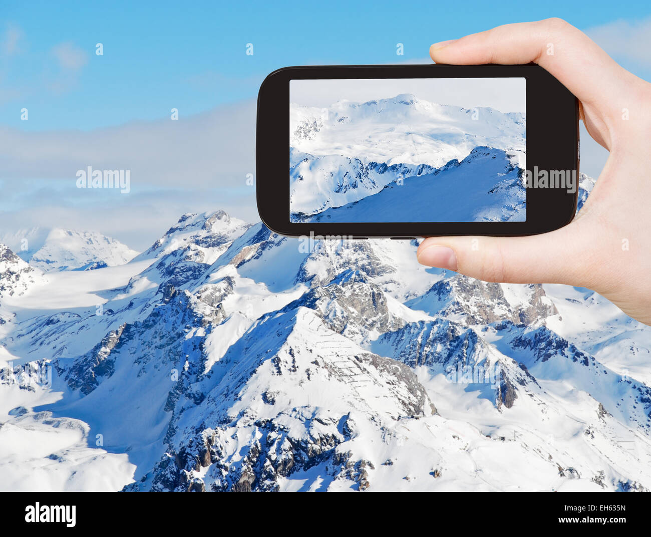 travel concept - tourist taking photo of snow mountains in Alpes ...