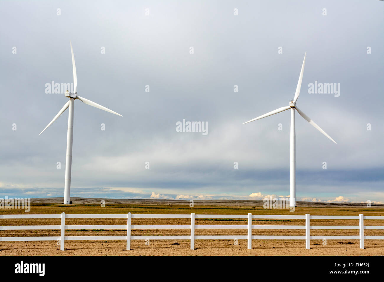 Wind turbines and a white fence Stock Photo - Alamy