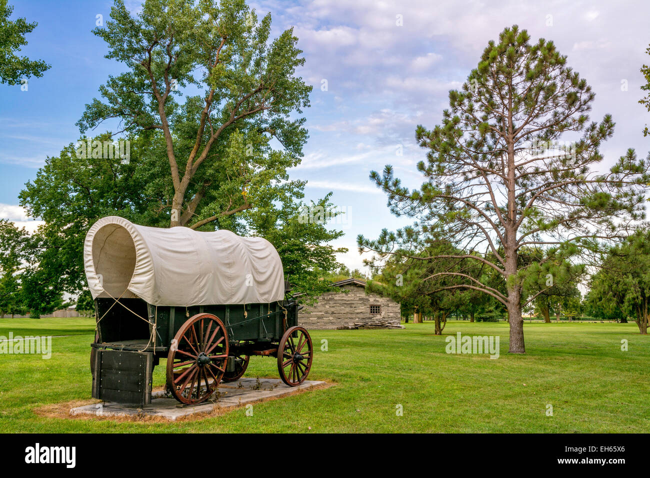 Rustic covered wagon and a park Stock Photo - Alamy