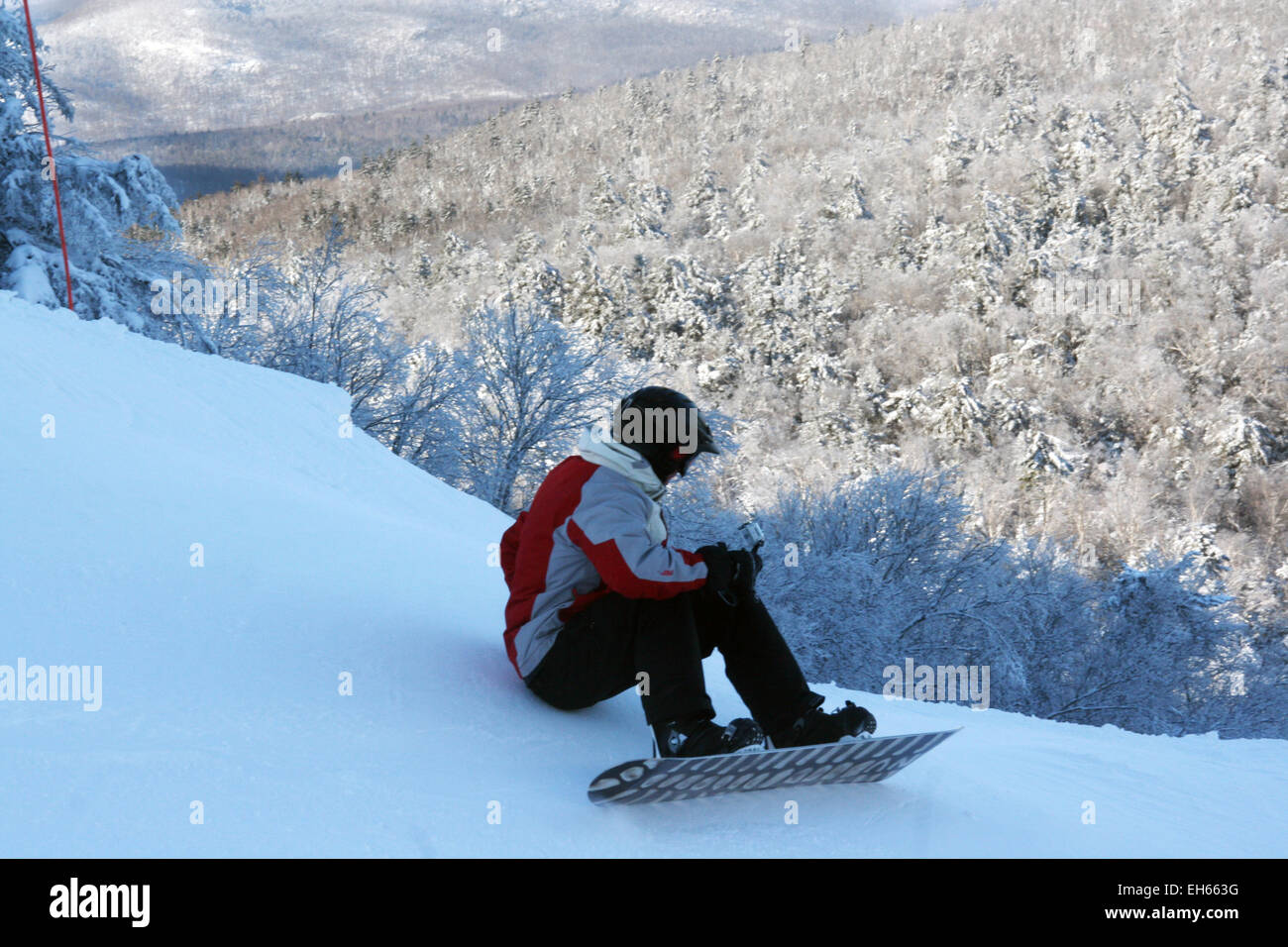 A snowboarder resting on a slope Stock Photo - Alamy
