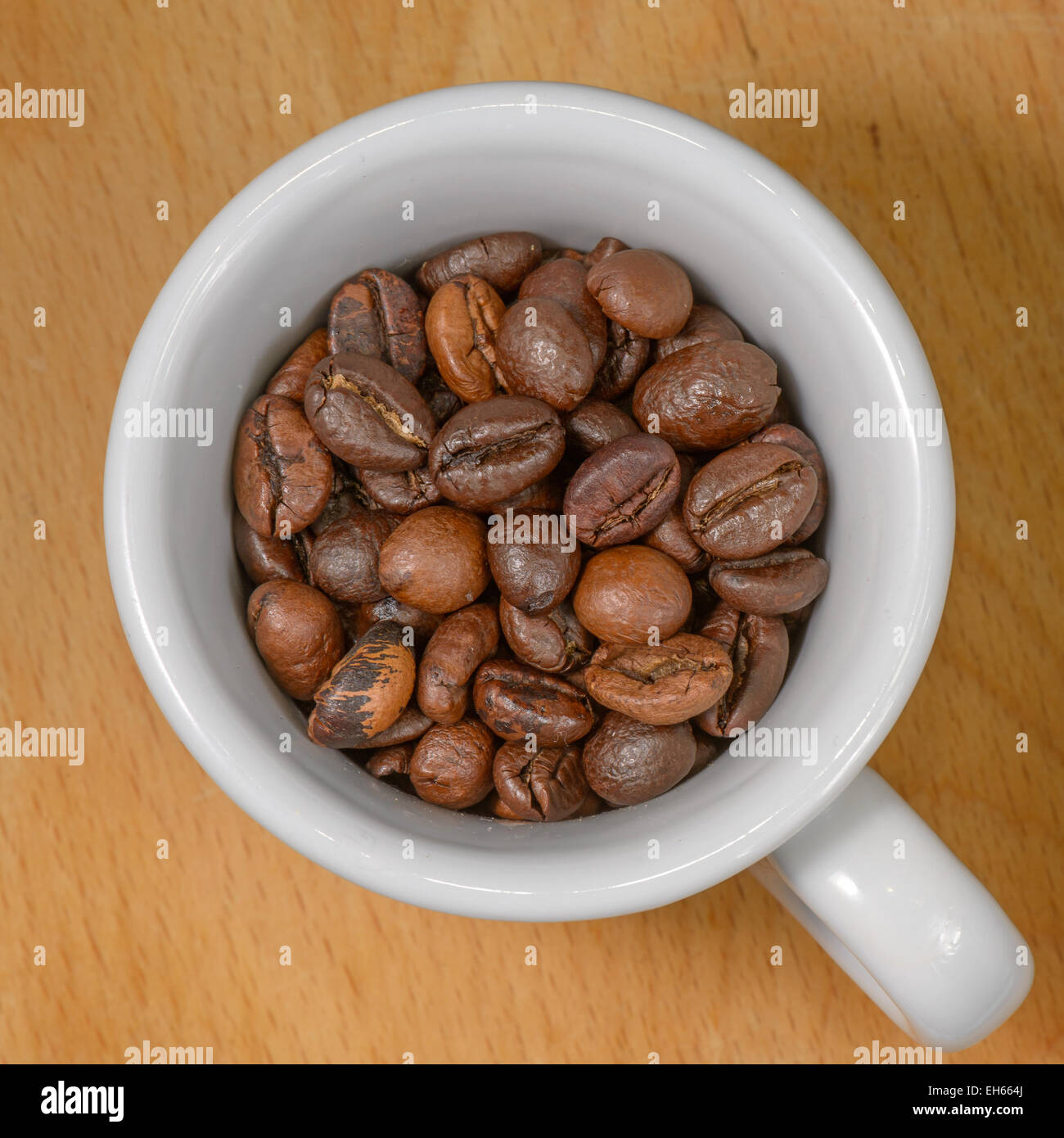 Nice cup of coffe with toasted coffee seeds inside on wood background ...