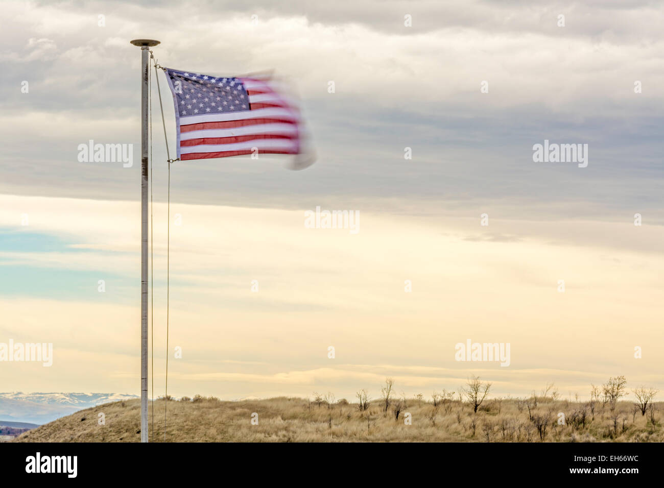 Flapping in the wind is stars and strip flag Stock Photo - Alamy
