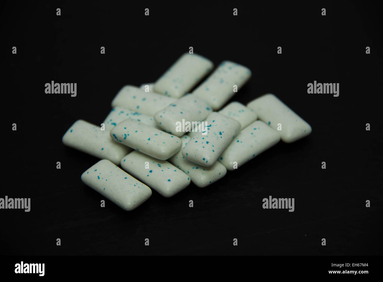 White mint candy isolated on blackt background Stock Photo - Alamy