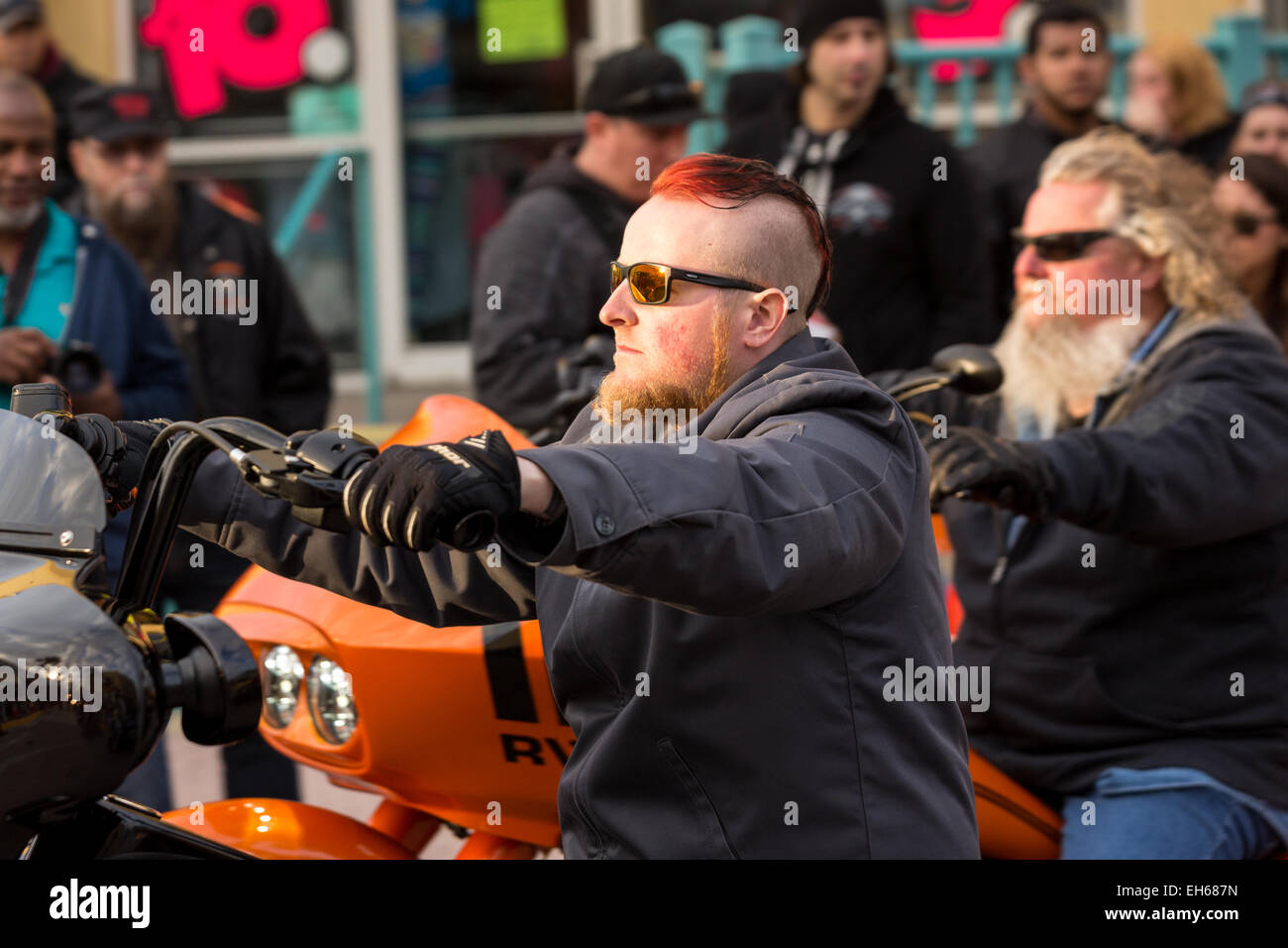 A biker with a mohawk haircut cruises down Main Street during the 74th ...