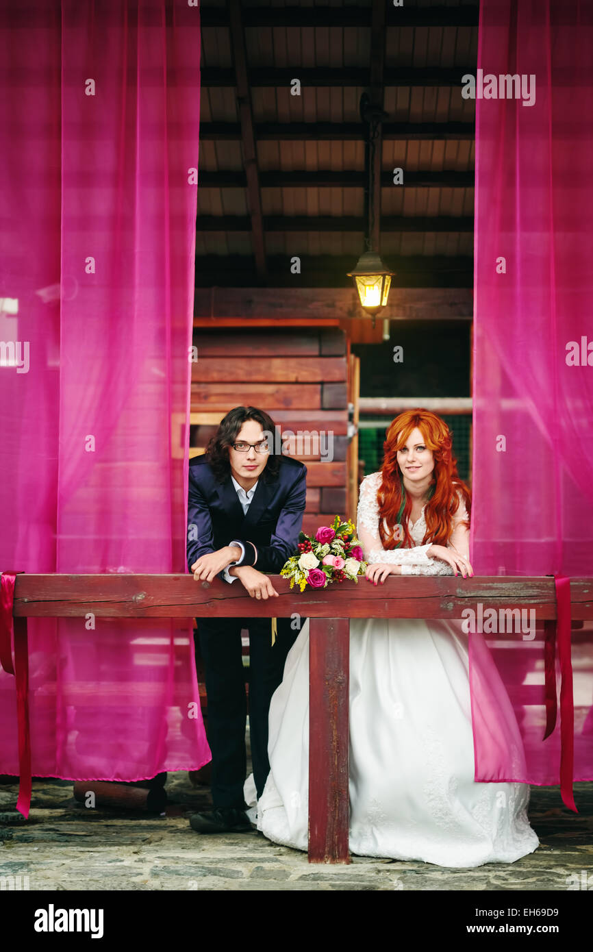 Happy young married couple, smiling. Red hair bride. Summer evening ...