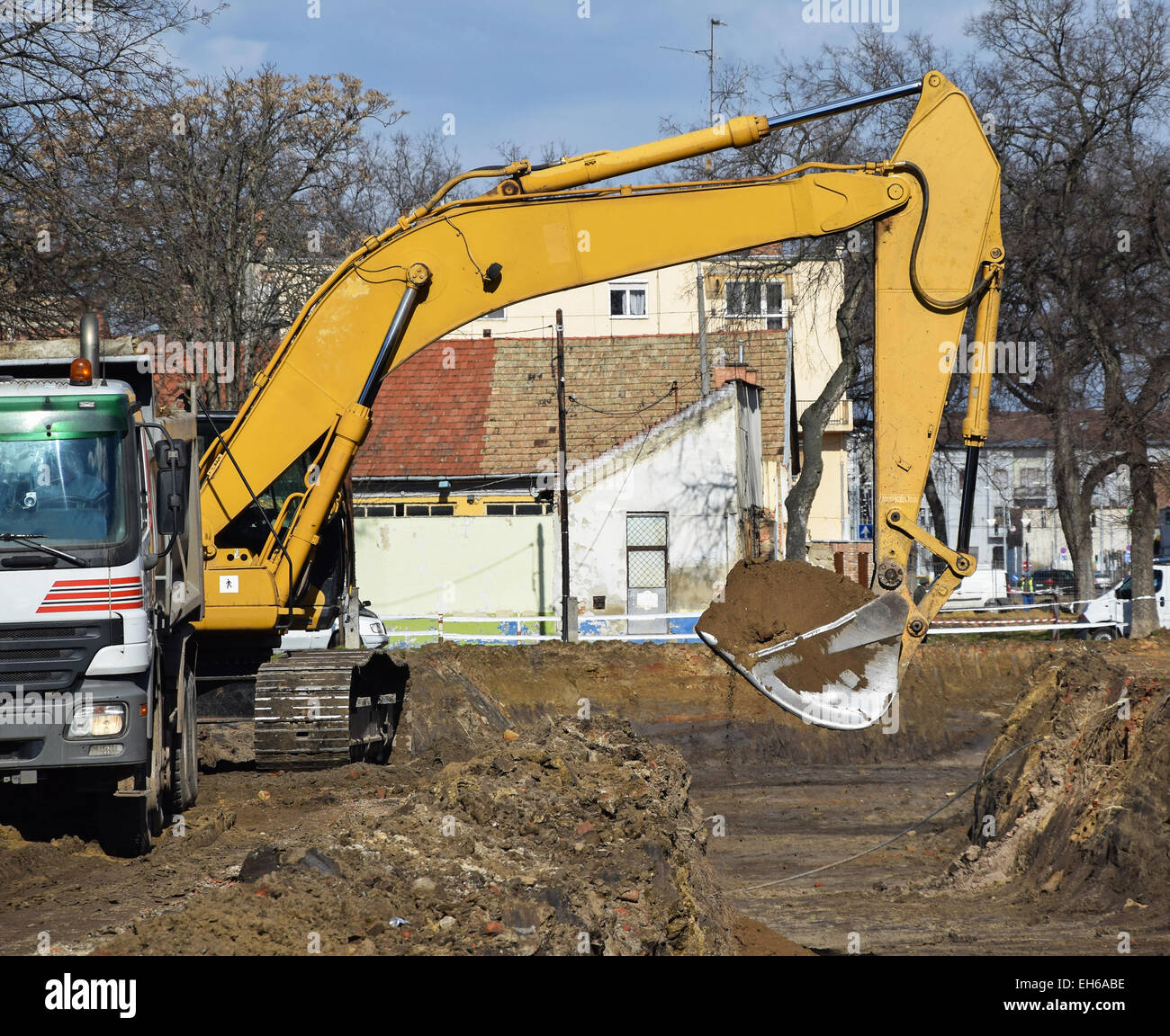 Excavator is working at the road construction Stock Photo - Alamy