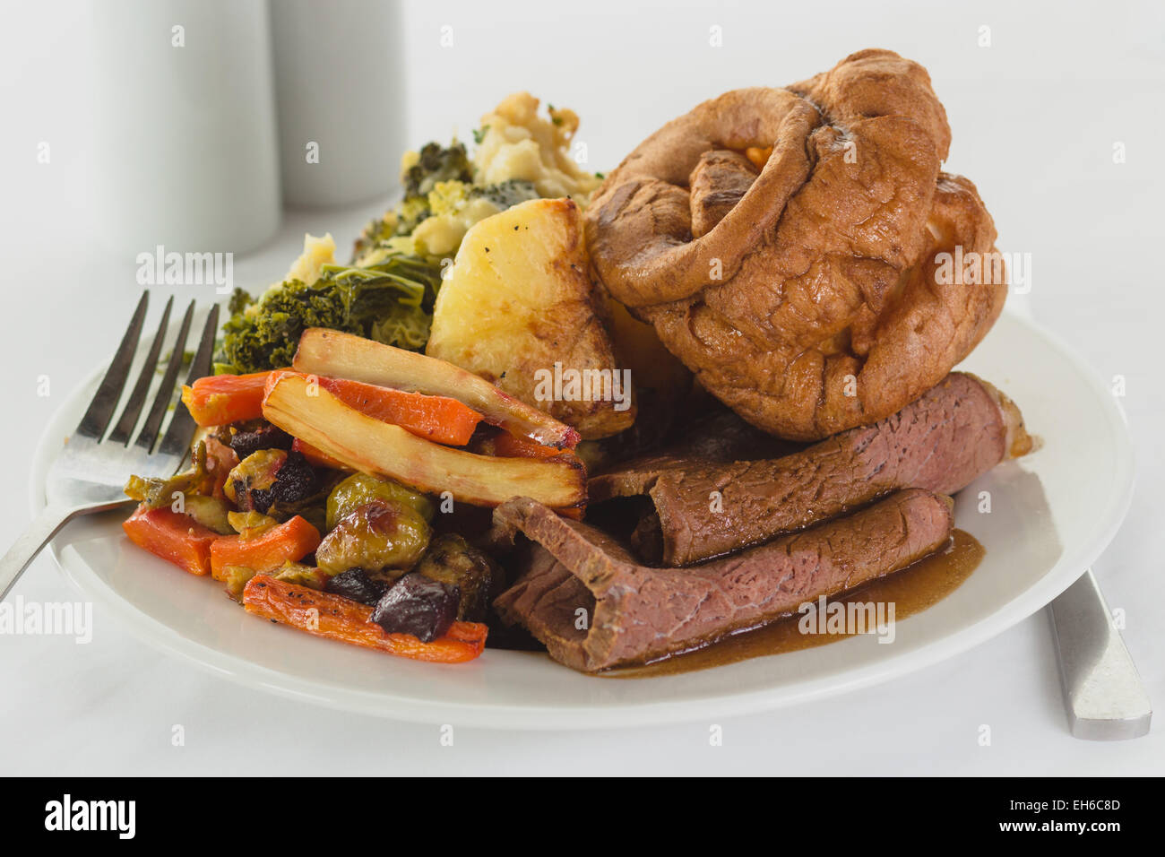 Plated Beef roast dinner with knife and fork on light background Stock ...