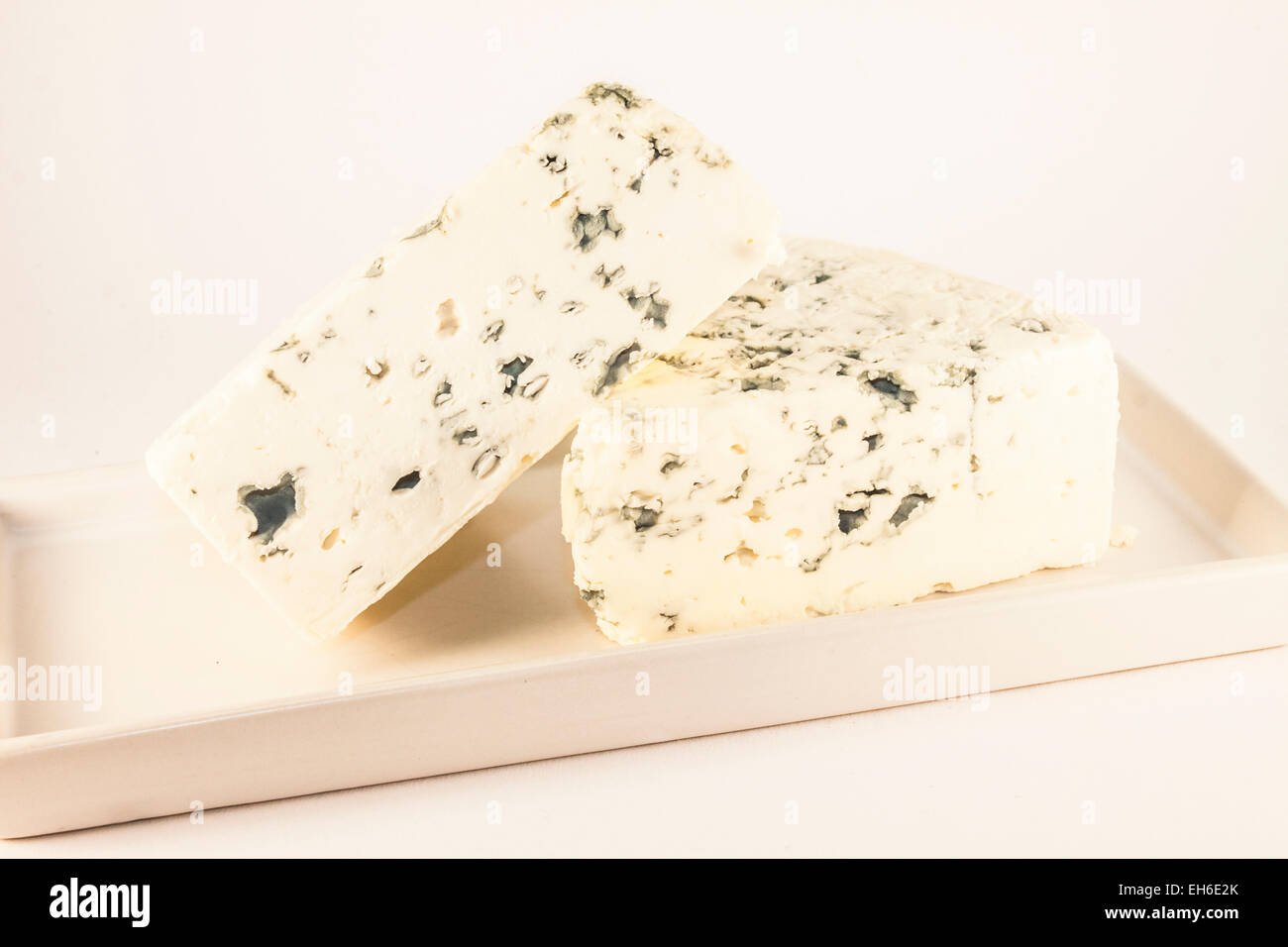 Two triangles of blue cheese, isolated on white background Stock Photo ...