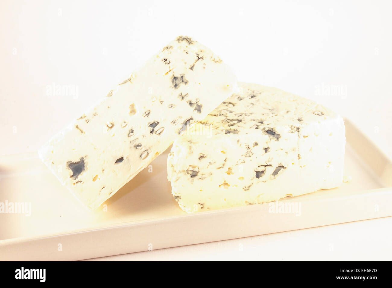 Two triangles of blue cheese, isolated on white background Stock Photo ...