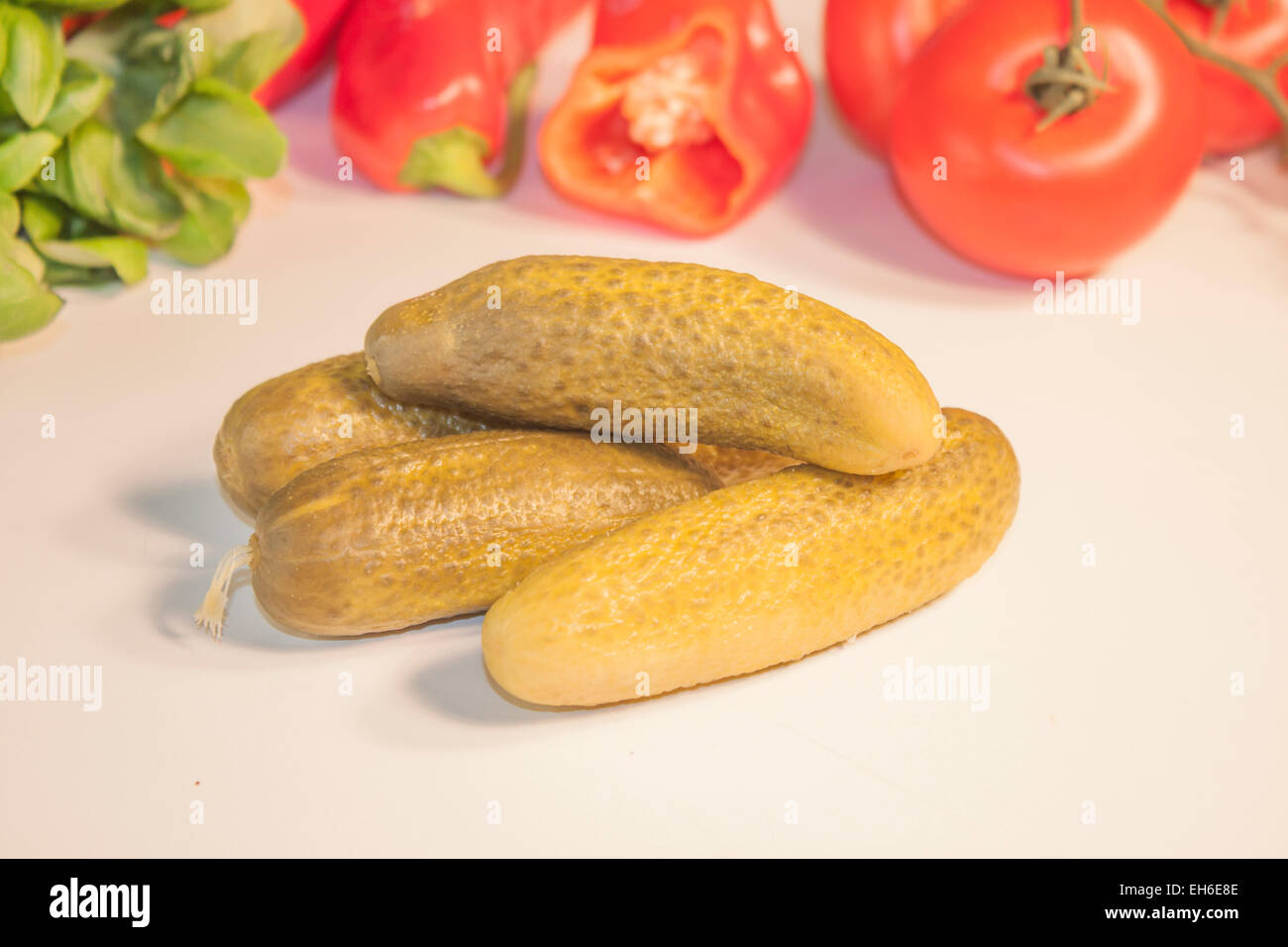 A few pickles, in front of vegetables and herbs Stock Photo - Alamy