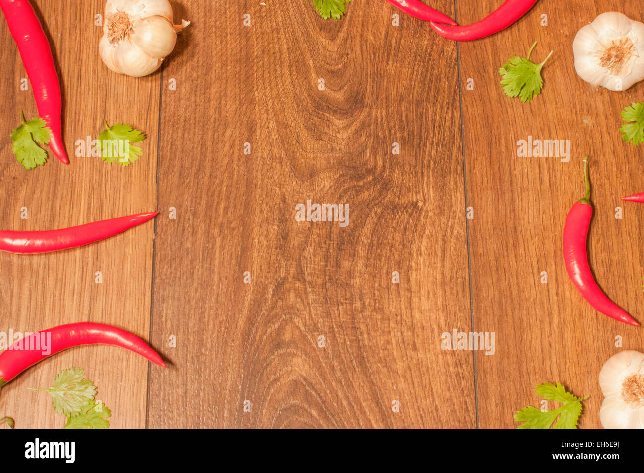 Garlic, chili and coriander, on wooden background Stock Photo - Alamy