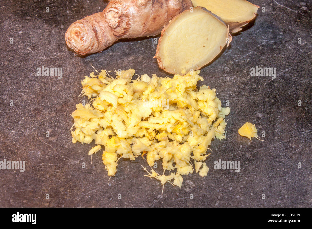 Yellow ginger grate and ginger, on a stone plate Stock Photo - Alamy