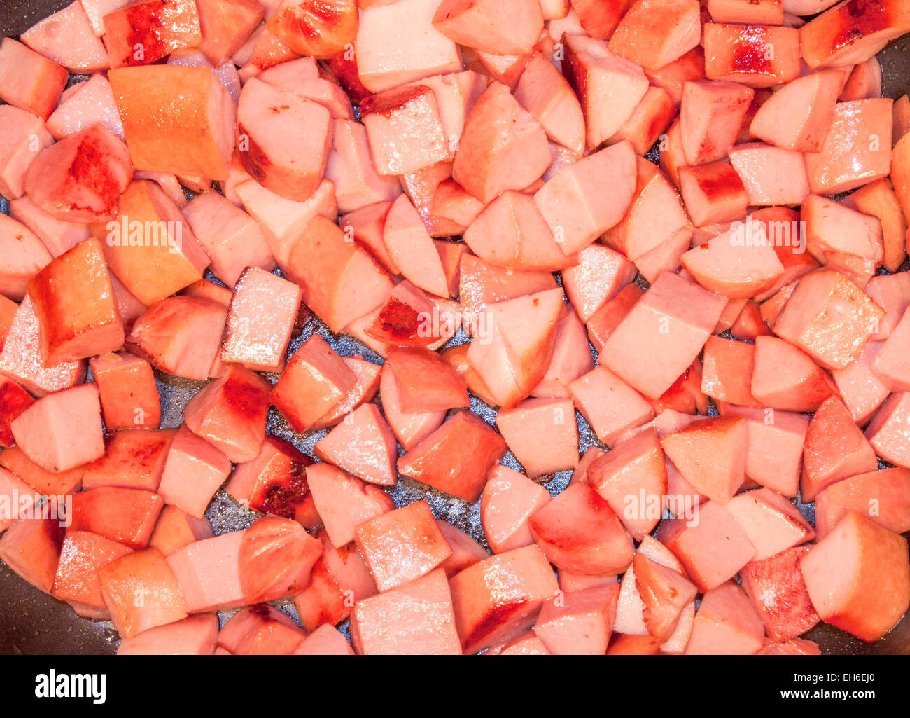 A lot of fried sausage dice, on a frying pan Stock Photo - Alamy