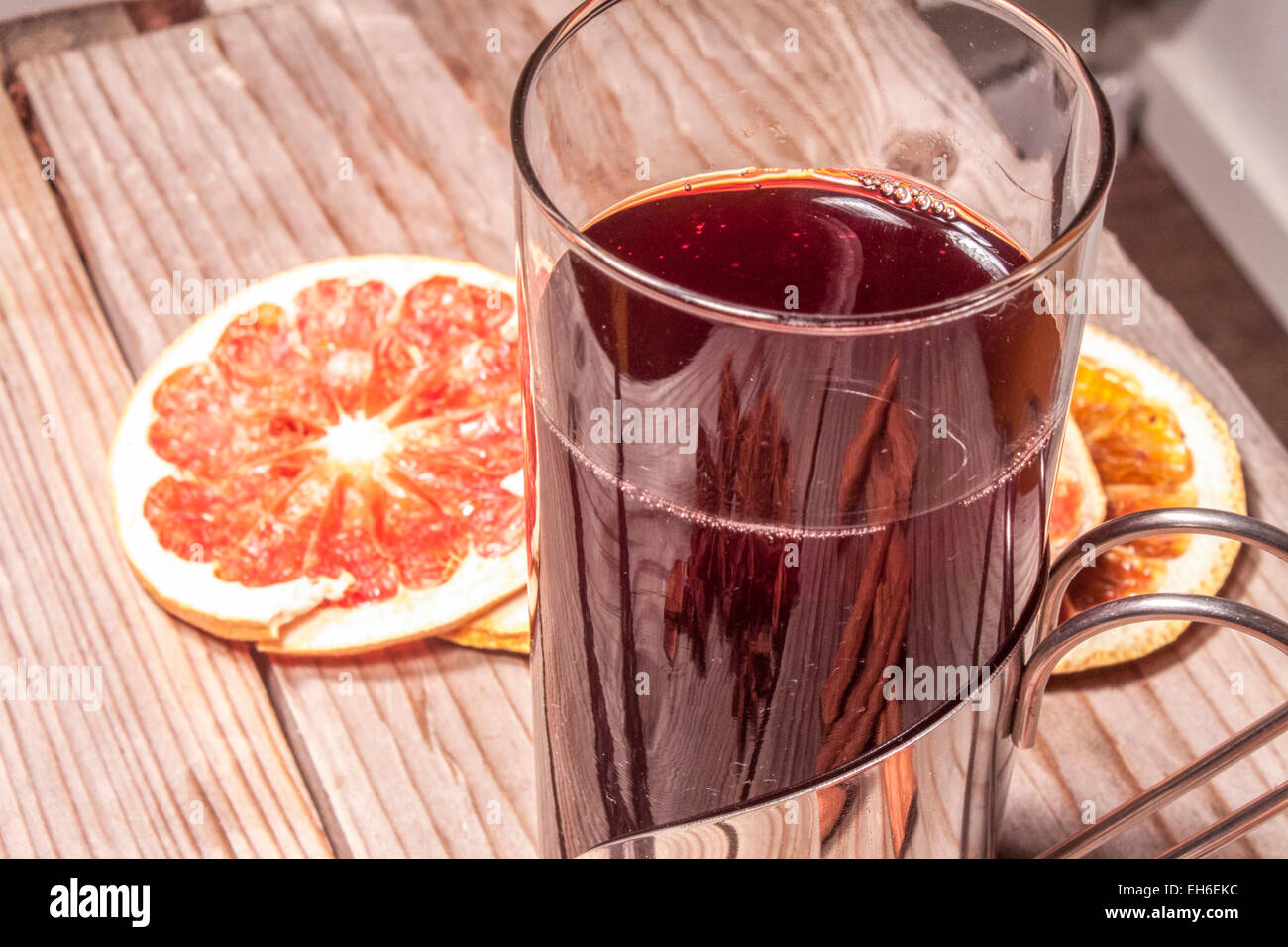 A glass with glogg and dry grape and orange Stock Photo - Alamy