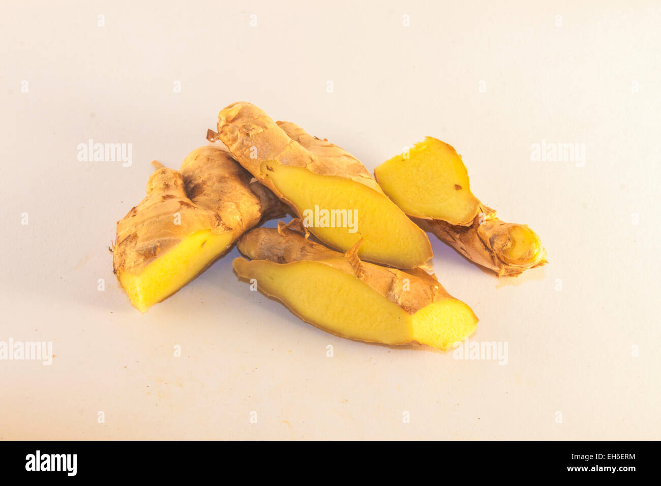 Yellow ginger bits, isolated on white background Stock Photo - Alamy