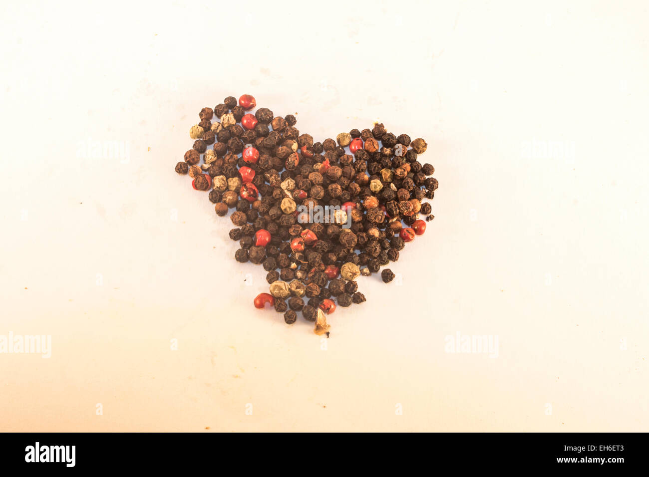 Pepper mix heart, isolated on white background Stock Photo - Alamy